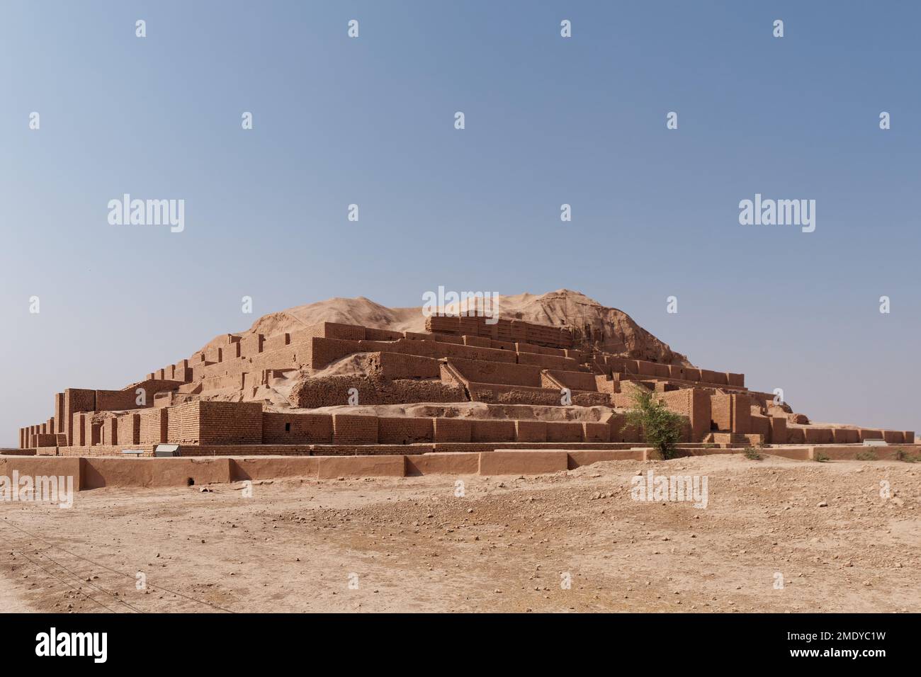 A beautiful shot of the historic Ziggurat of Chogha Zanbil under a blue ...