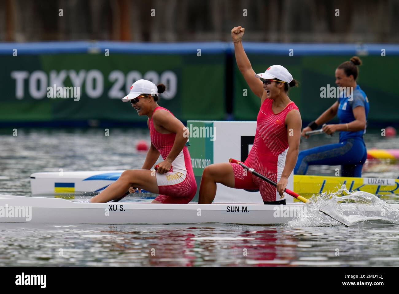 Shixiao Xu and Mengya Sun, of China, react after competing in the women ...