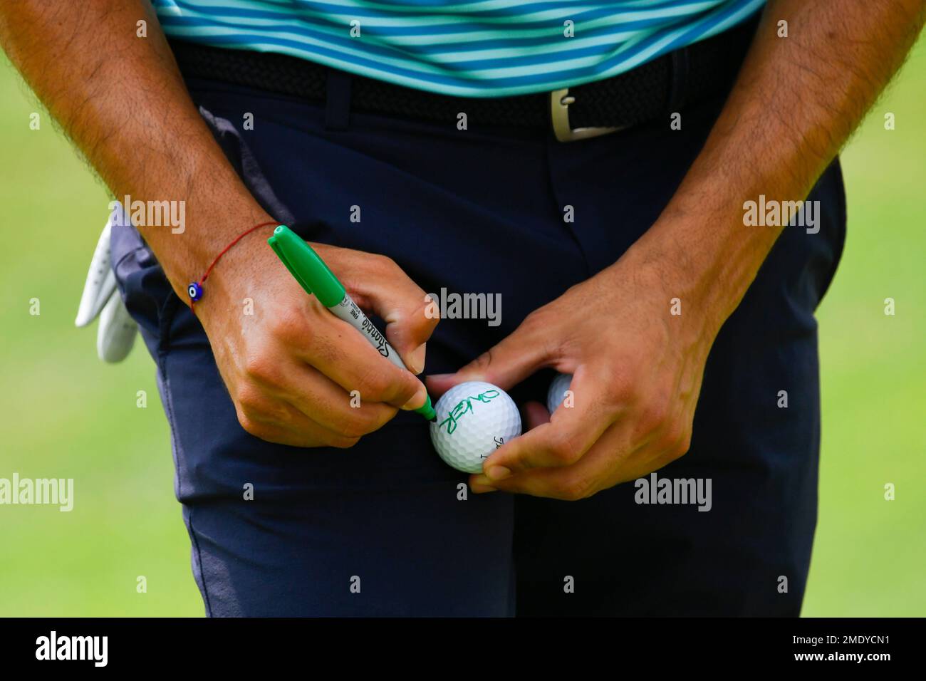 Abraham Ancer signs a golf ball after the second round in the World ...