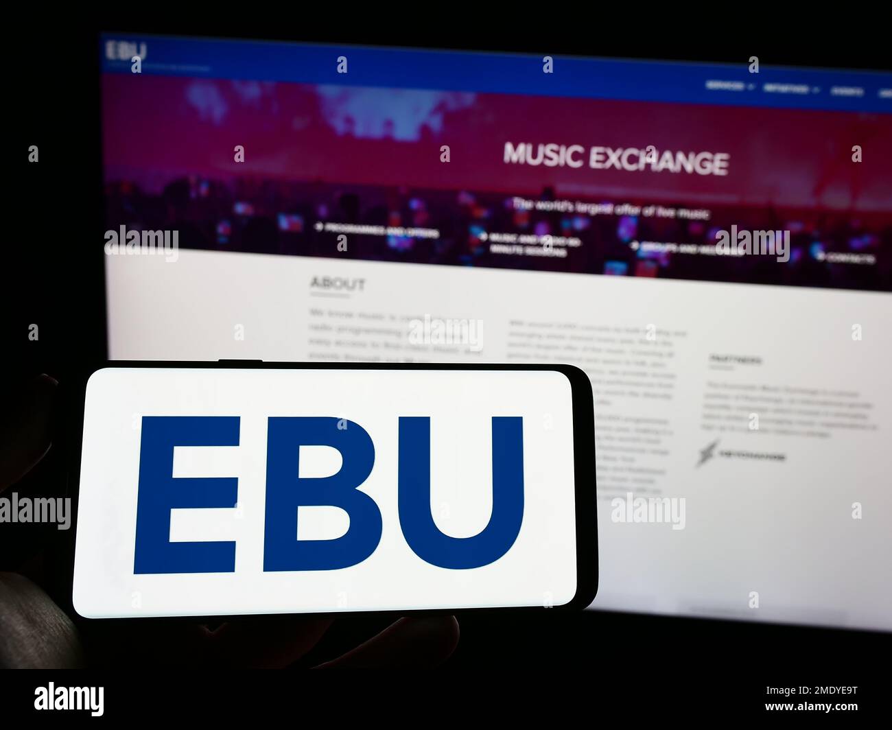 Person holding mobile phone with logo of European European Broadcasting ...