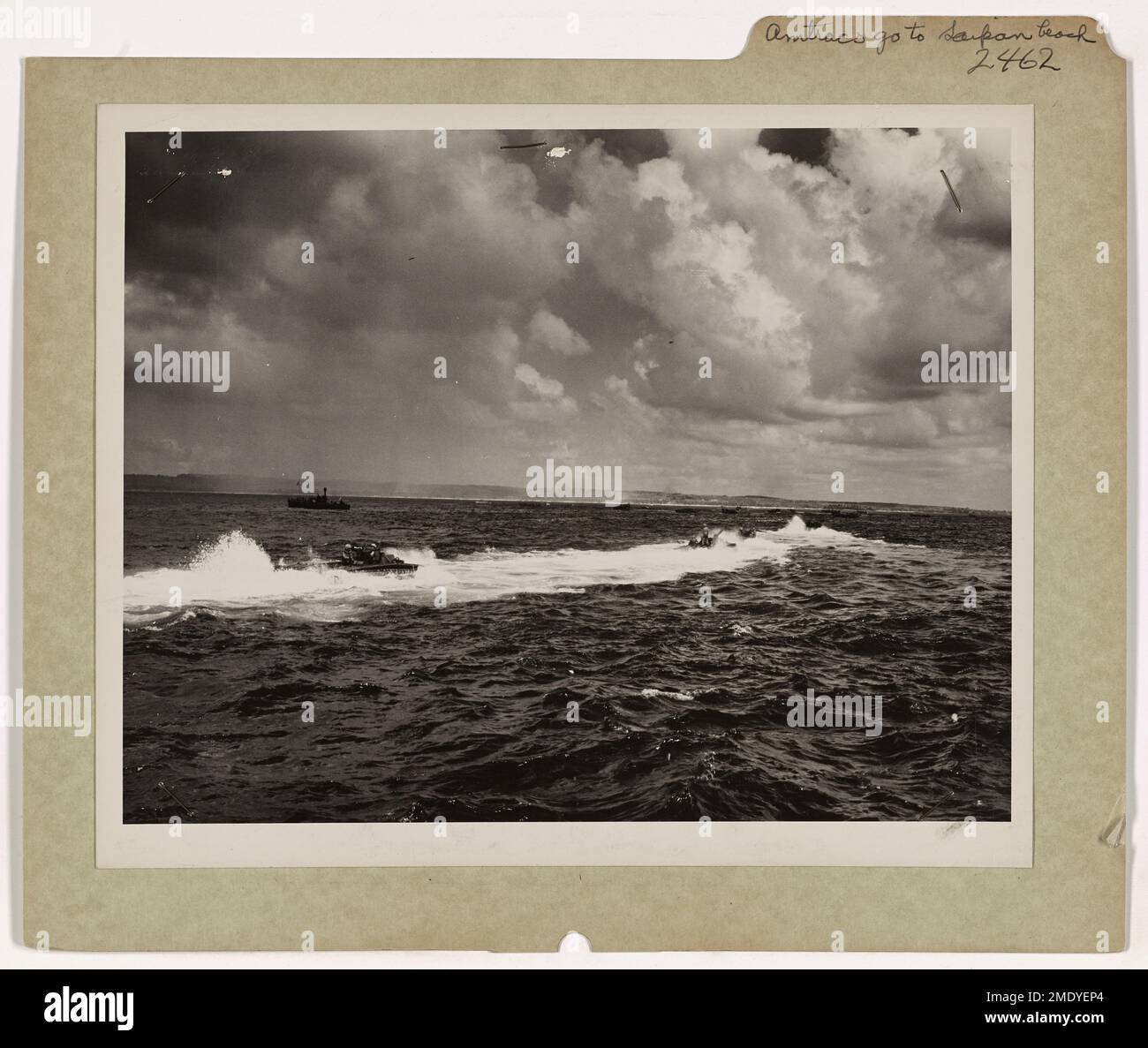 In this image, amphibious tractors (amtracs) head toward the smoky ...