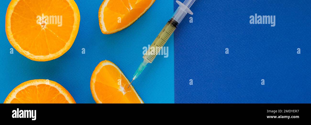 syringe is ready for mesotherapy injection. Orange in a Cut and Syringe ...