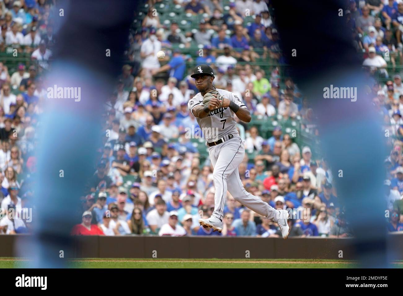 As seen through the legs of Chicago Cubs first base coach Craig Driver ...