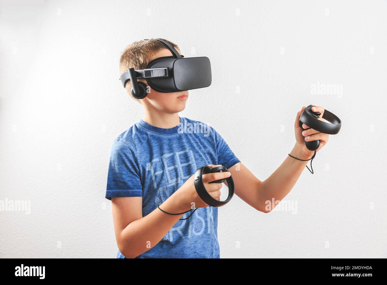 Teenager boy playing in virtual reality on whitebackground Stock Photo ...