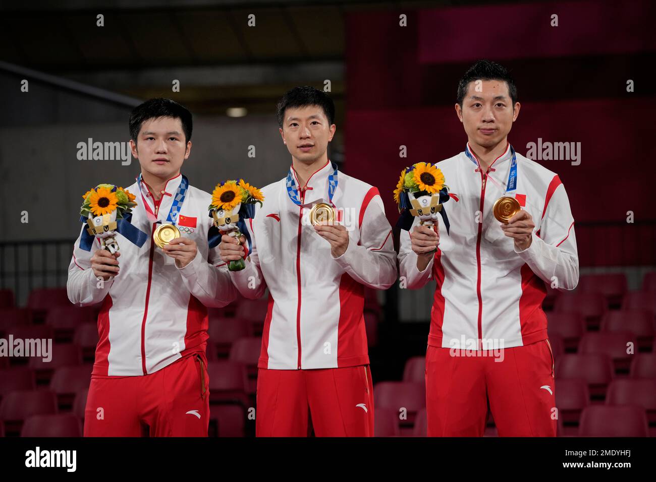 From left China's Fan Zhendong, Ma Long and Xu Xin pose with their gold ...