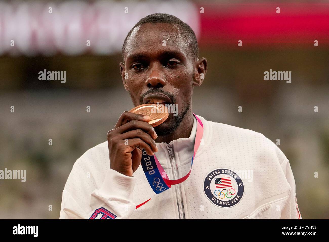 Bronze medalist Paul Chelimo, of the United States, poses during the ...