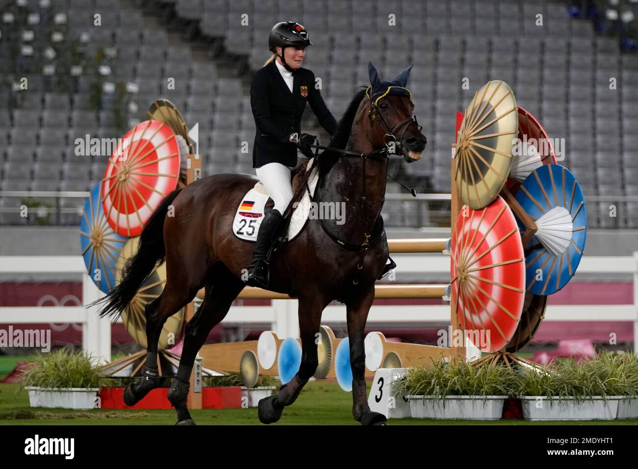 Annika Schleu of Germany cries as she couldn't controls her horse to ...