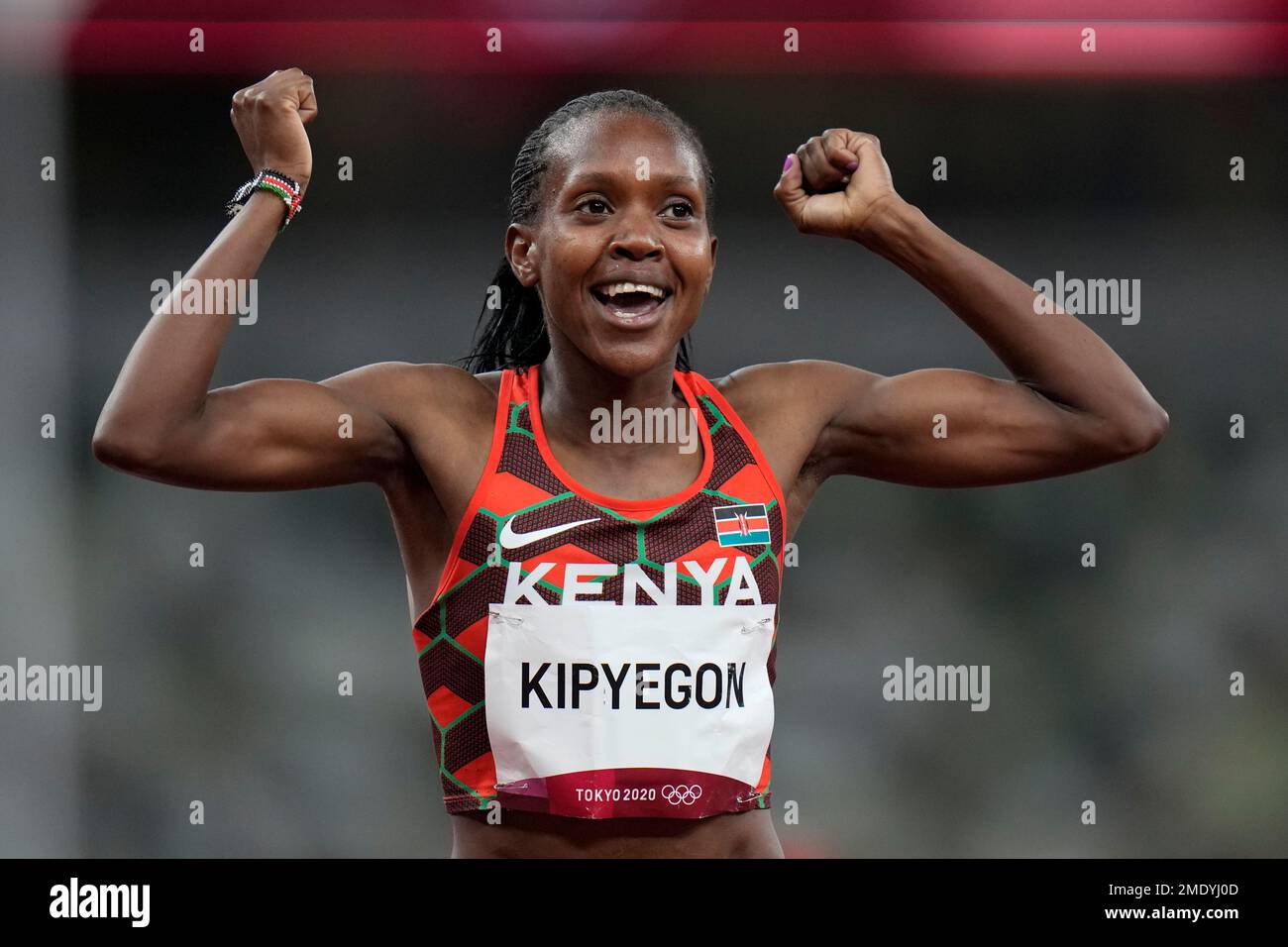 Faith Kipyegon, of Kenya, celebrates as she crosses the finish line ...