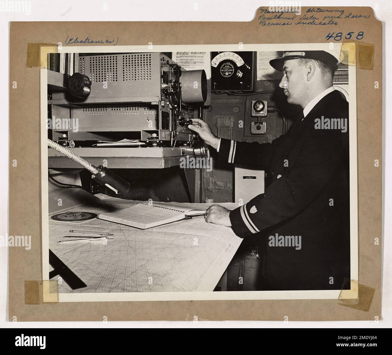 A navigator aboard a ship uses a Loran Receiver Indicator to gather ...