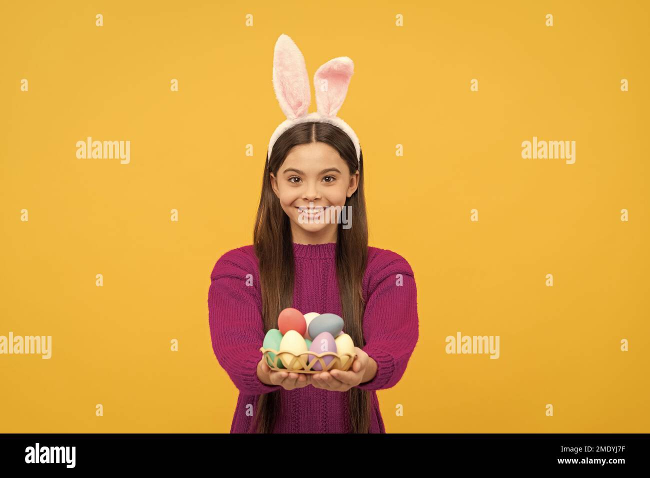 surprised teen kid in bunny ears with painted eggs for easter, easter ...