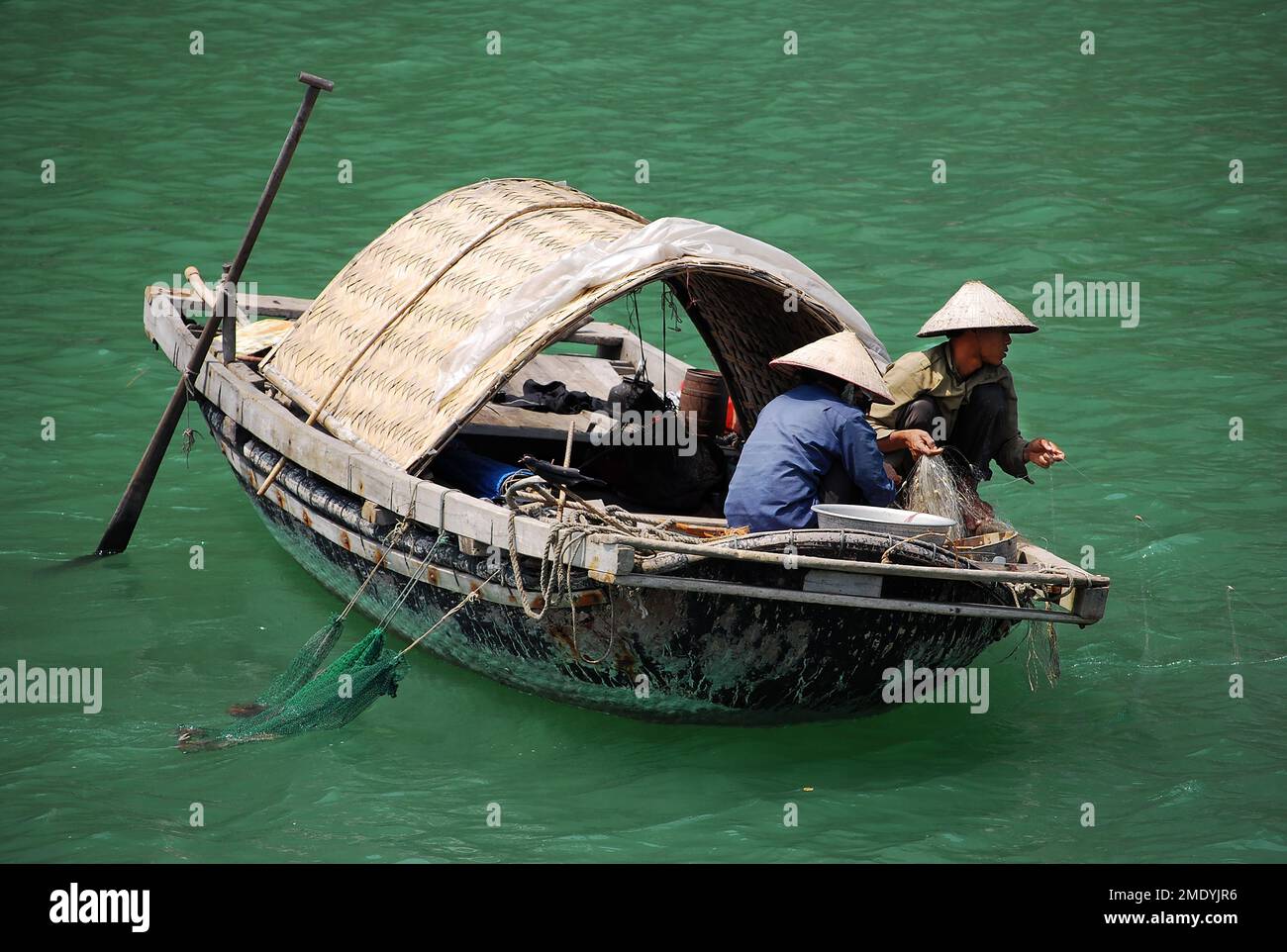 Vietnamese fishermen in Ha Long Bay. They live in floating villages in ...