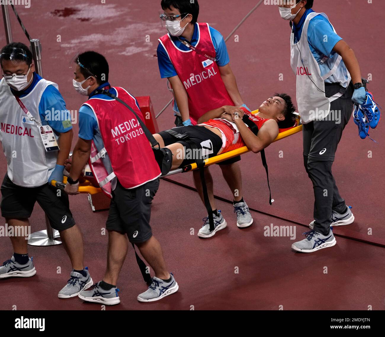 A member of Team Japan is assisted from the track after a semifinal of ...