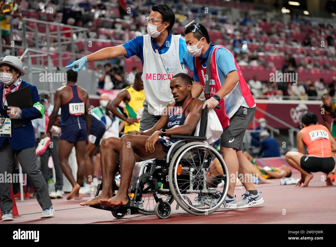 Gilles Baron of France is taken from the track in a wheelchair ...