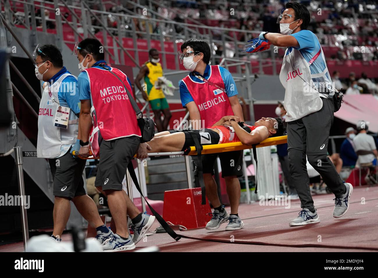 A member of team Japan is taken from the track on a stretcher ofter a ...