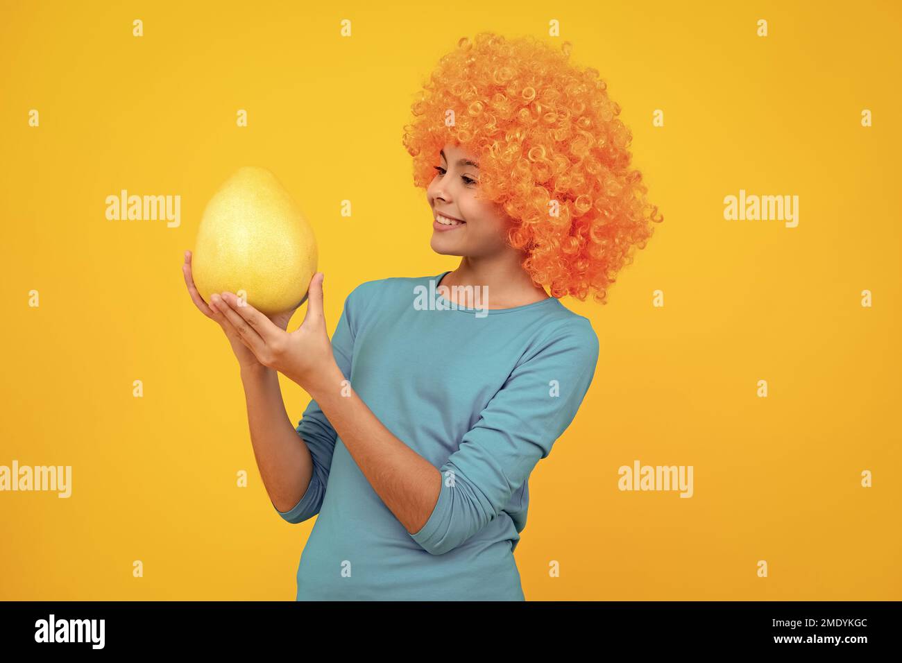 Summer fruits. Teenager child girl hold citrus fruit pummelo or pomelo ...