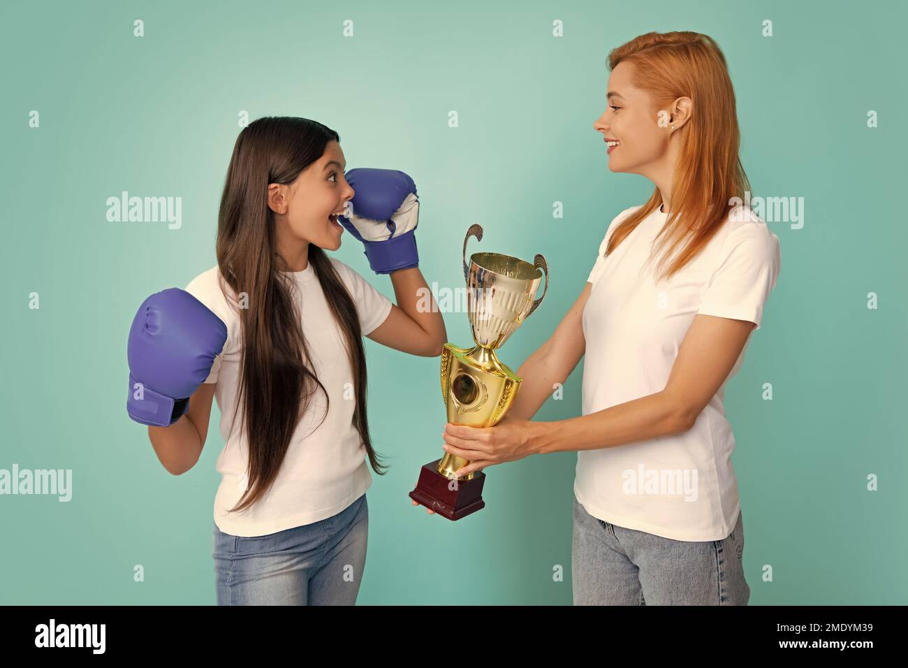 Mother and teen daughter wearing boxing gloves, emotional excited and ...