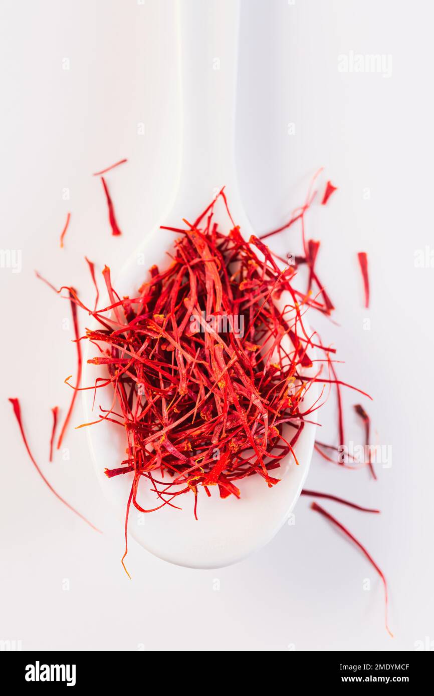 Saffron in white spoon on white background. Natural dry saffron threads ...