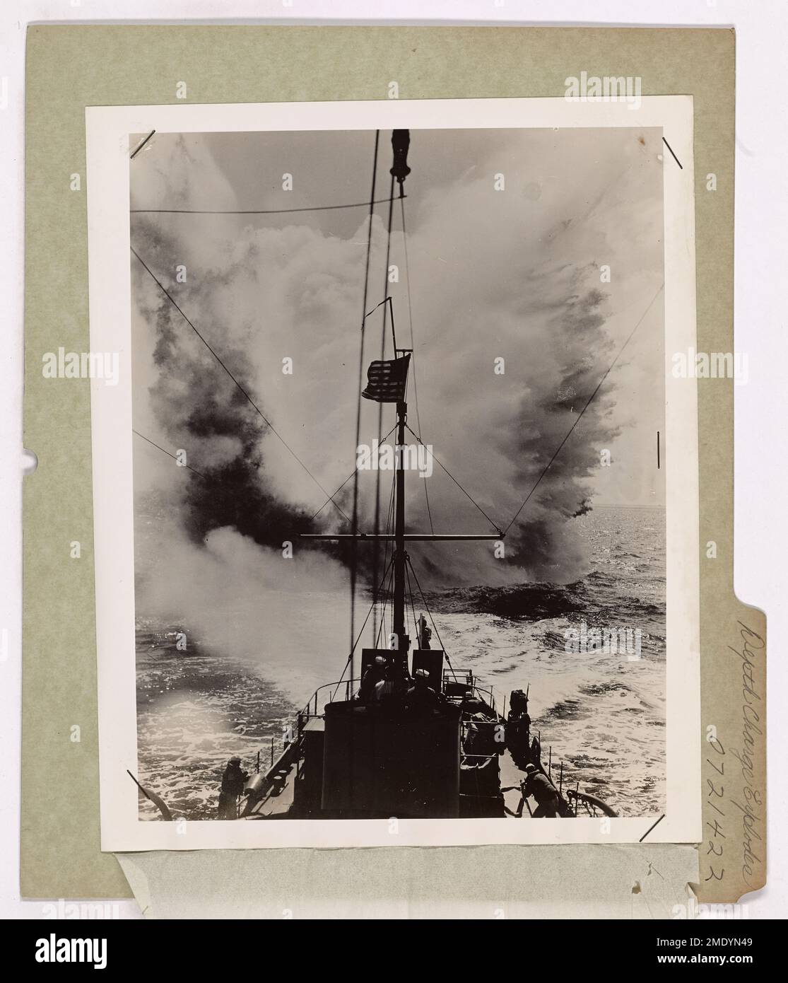 A Coast Guard ship is shown as a depth charge explodes in the water ...