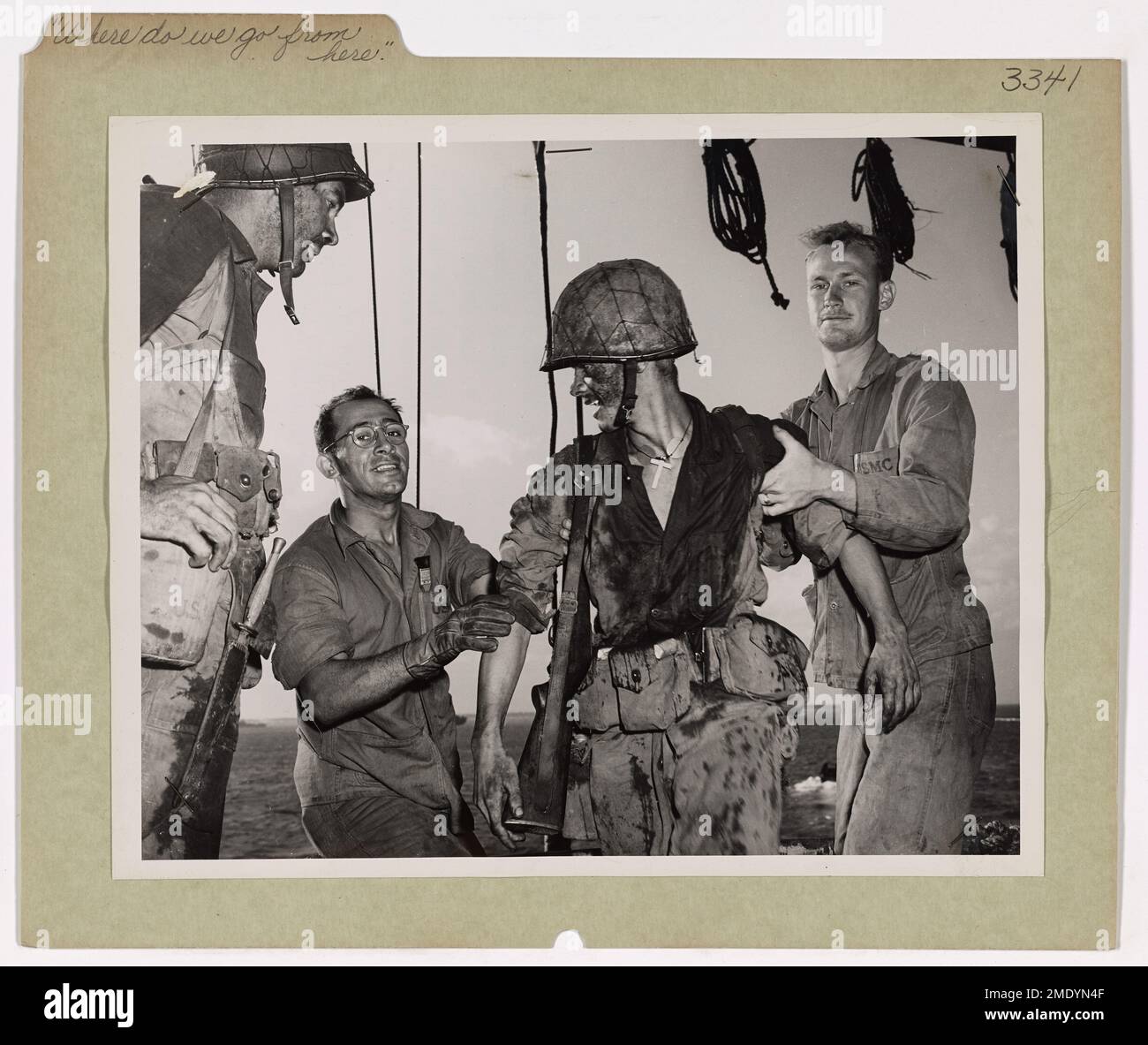 Coast Guardsmen and Marines return aboard their assault transport after ...