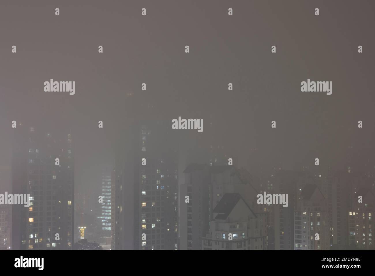A fog-shrouded night city view, fine dust, air pollution Stock Photo ...