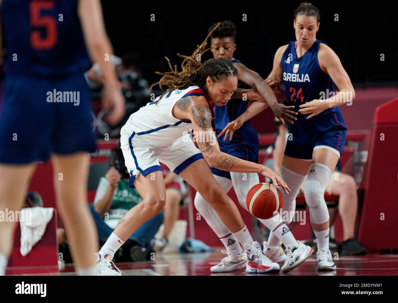 United States' Brittney Griner (15), left, drives around Serbia's Maja ...