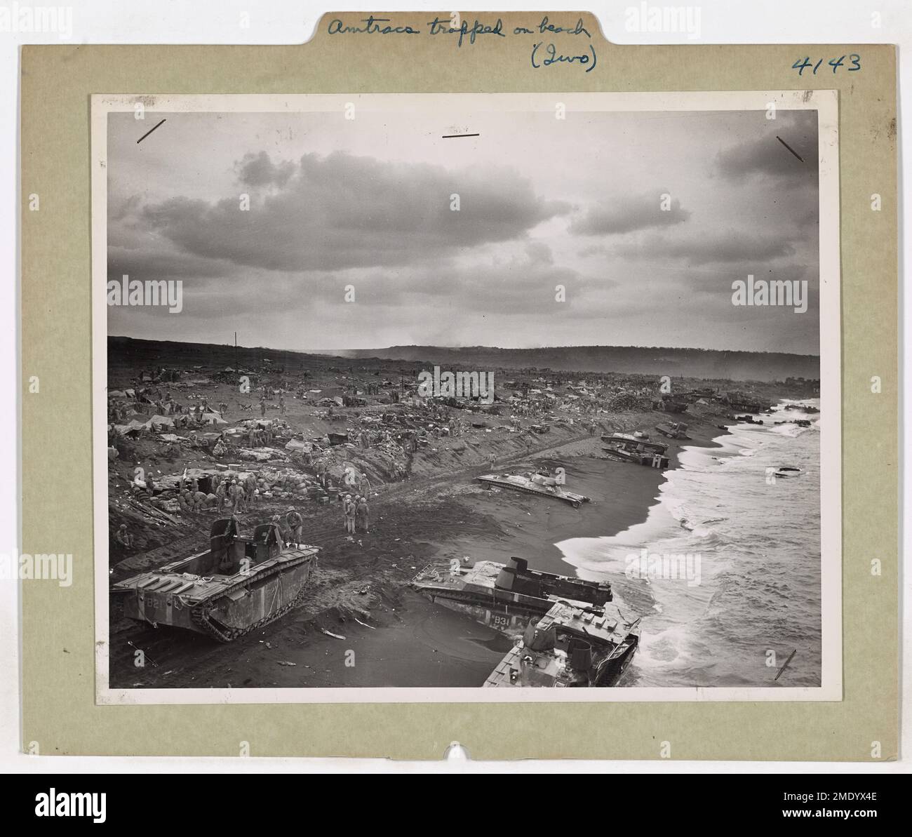 Amtracs (amphibious tractors) are bogged down in the sand during the ...