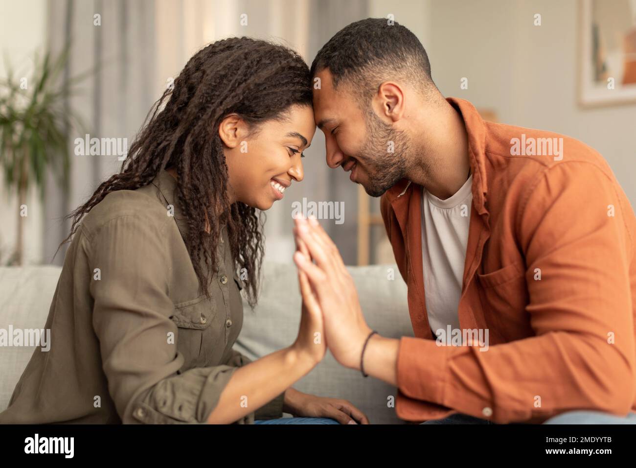 Romantic african american spouses holding their hands, touching ...