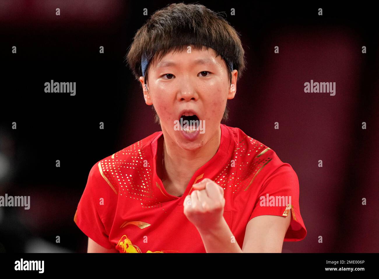 Wang Manyu of China reacts while competing during her table tennis ...