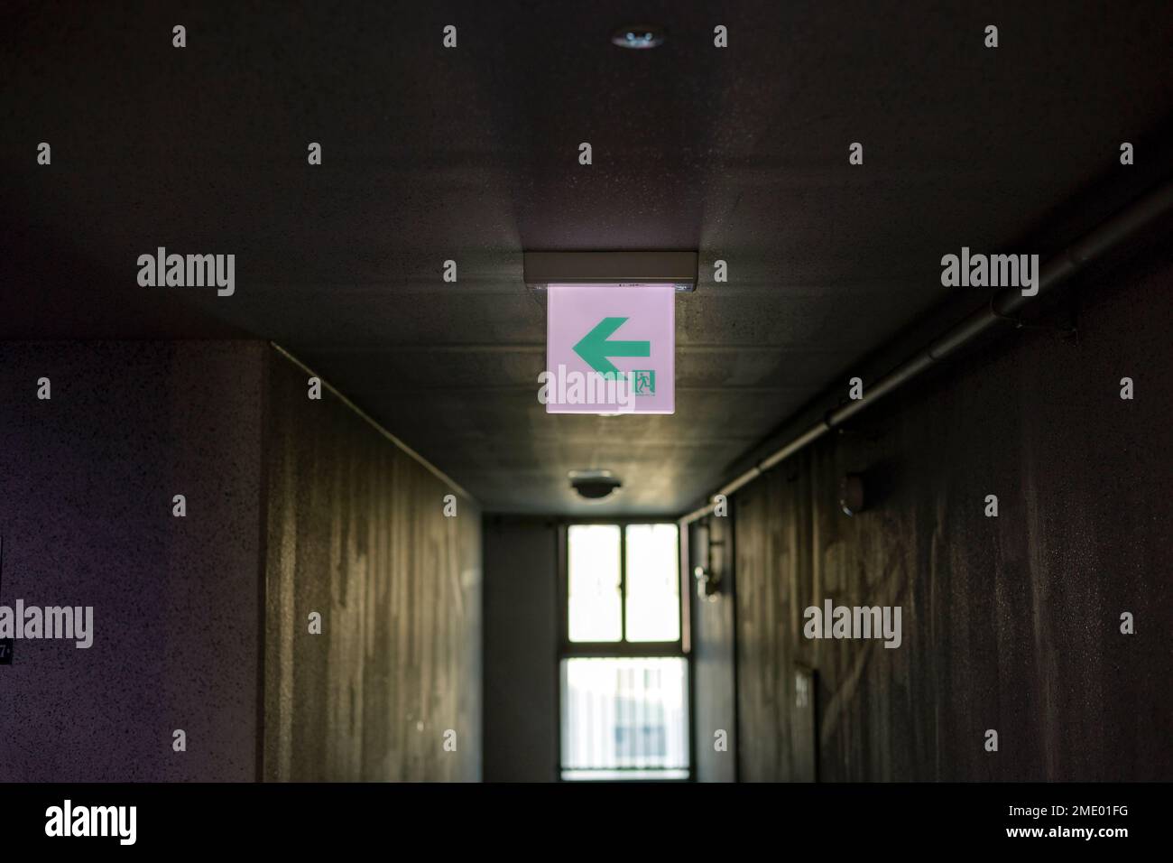 Emergency exit sign at the hallway of building Stock Photo - Alamy