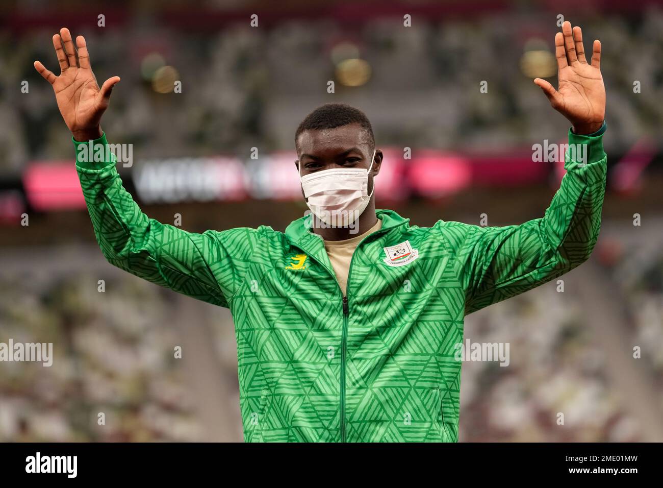 Bronze medalist Hugues Zango, of Burkina Faso, waves during the medal ...
