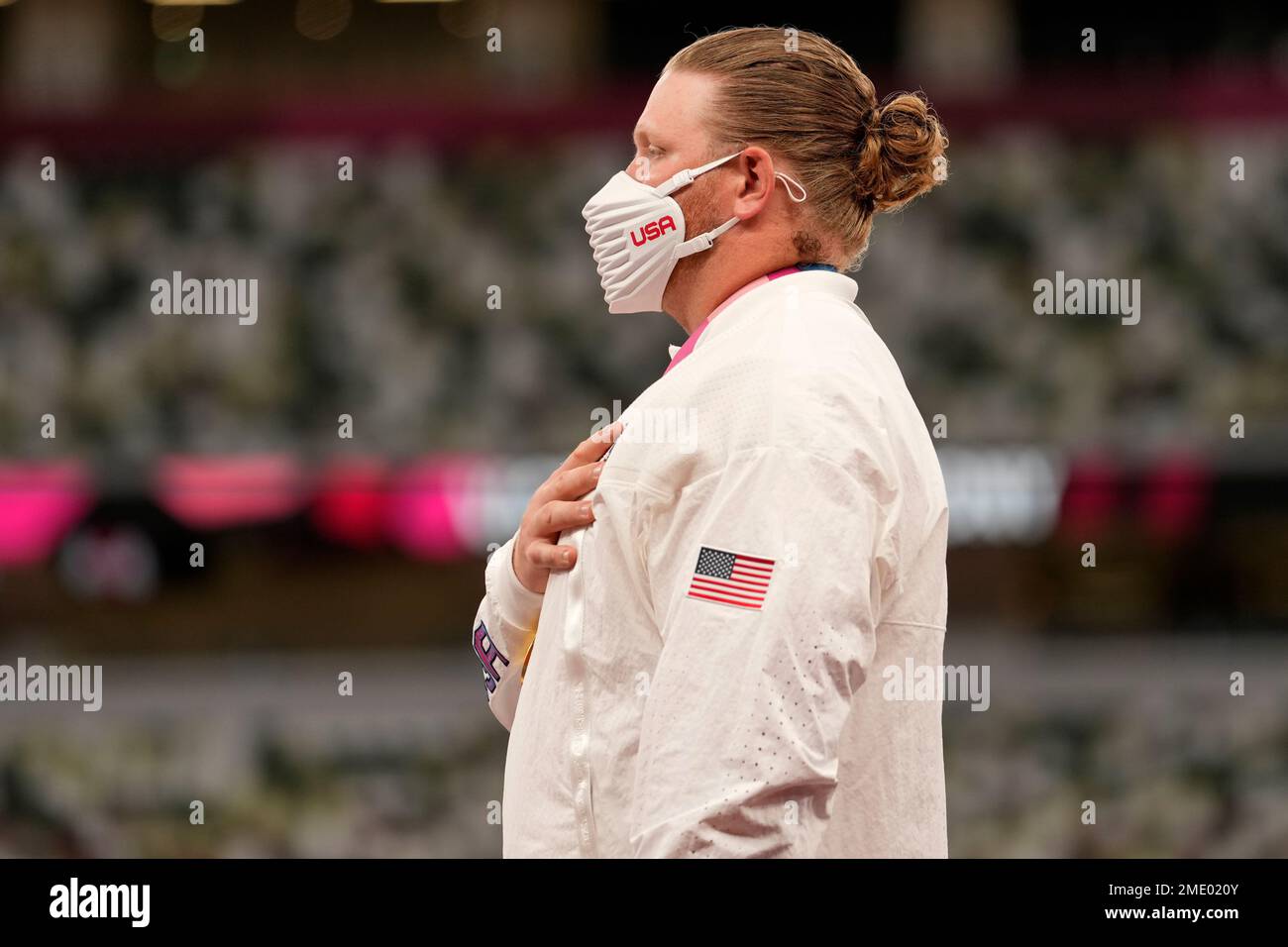 Gold medalist Ryan Crouser, of the United States, stands during the ...