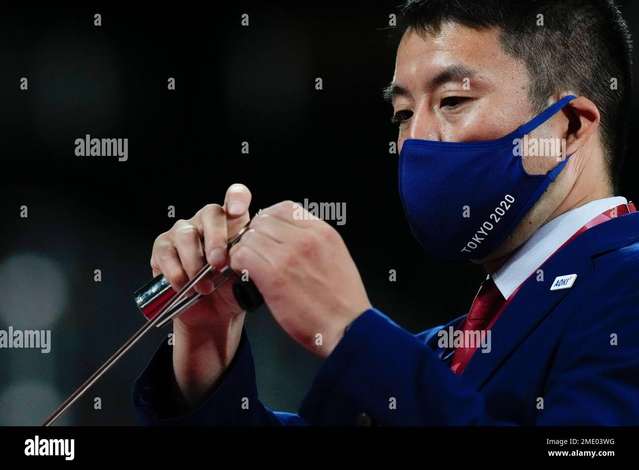 A referee checks an epee during the fencing portion of the women's ...