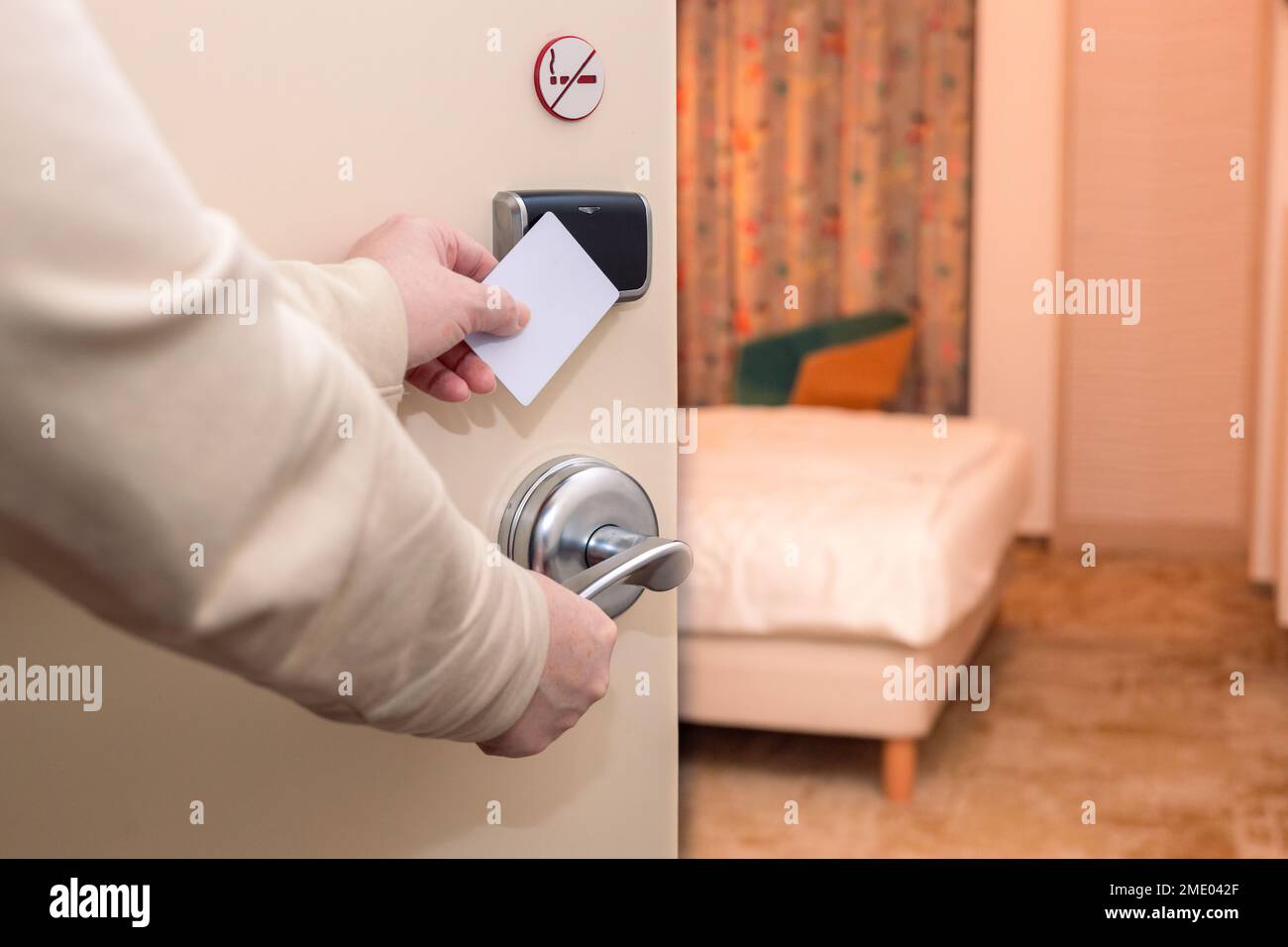 A woman opens a hotel room door with an access card Stock Photo - Alamy