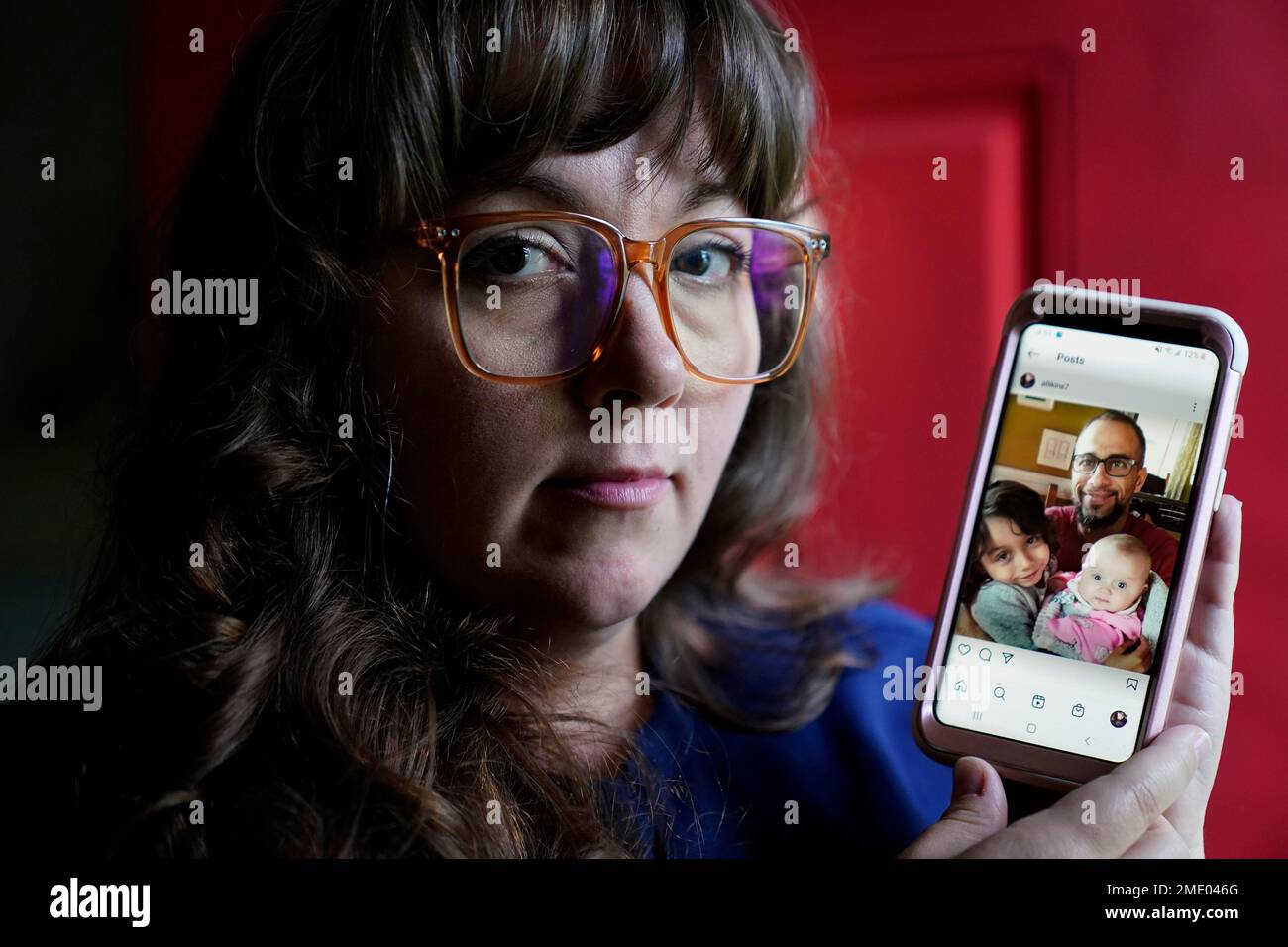 Allison Cullen, of Brockton, Mass., left, displays a family photo on ...