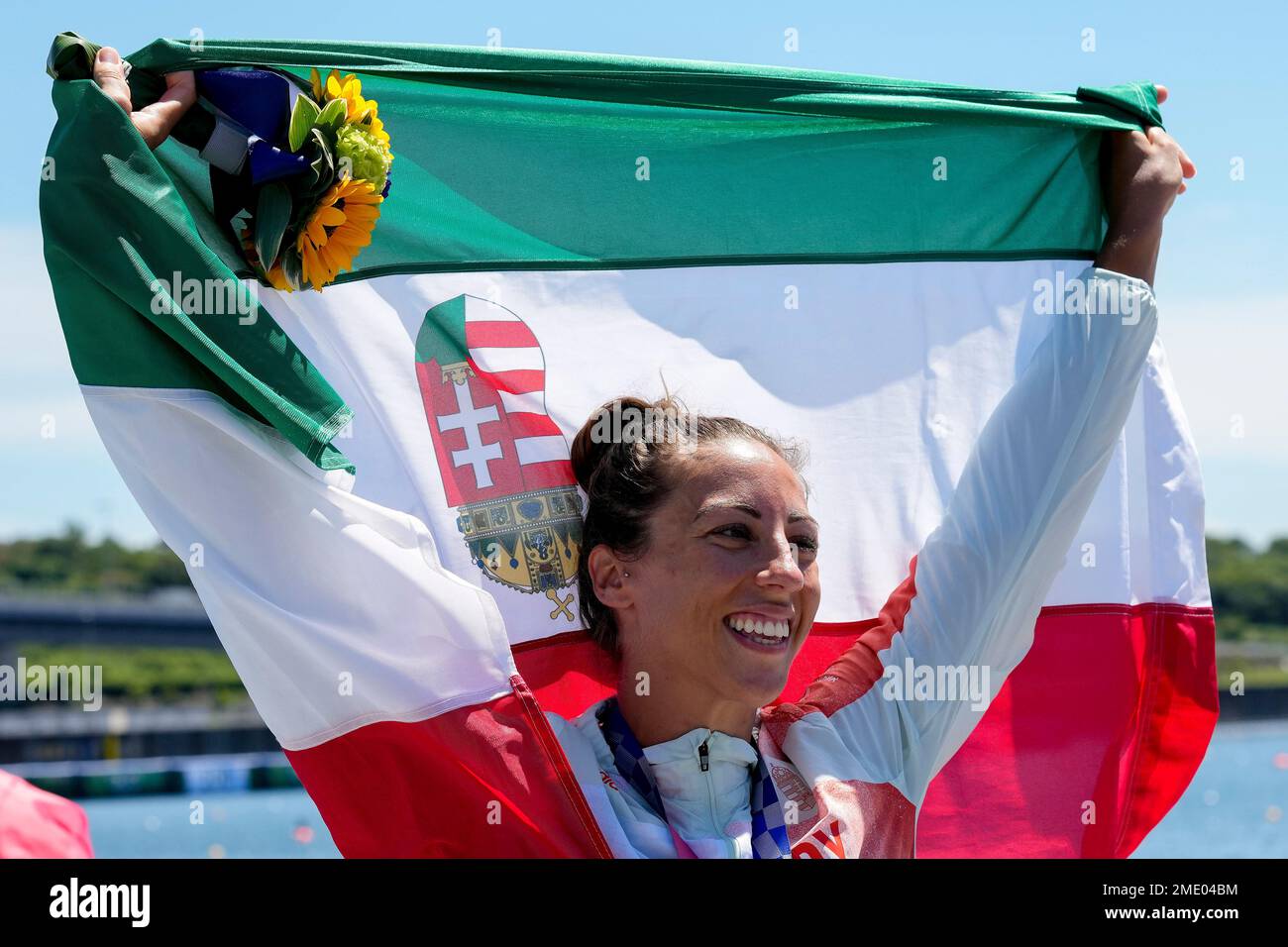 Tamara Csipes, of Hungary, waves the Hungarian flag after winning the ...