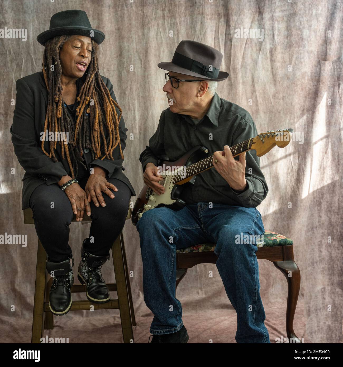 Senior African-American Woman and Senior White Man Singing and Playing ...