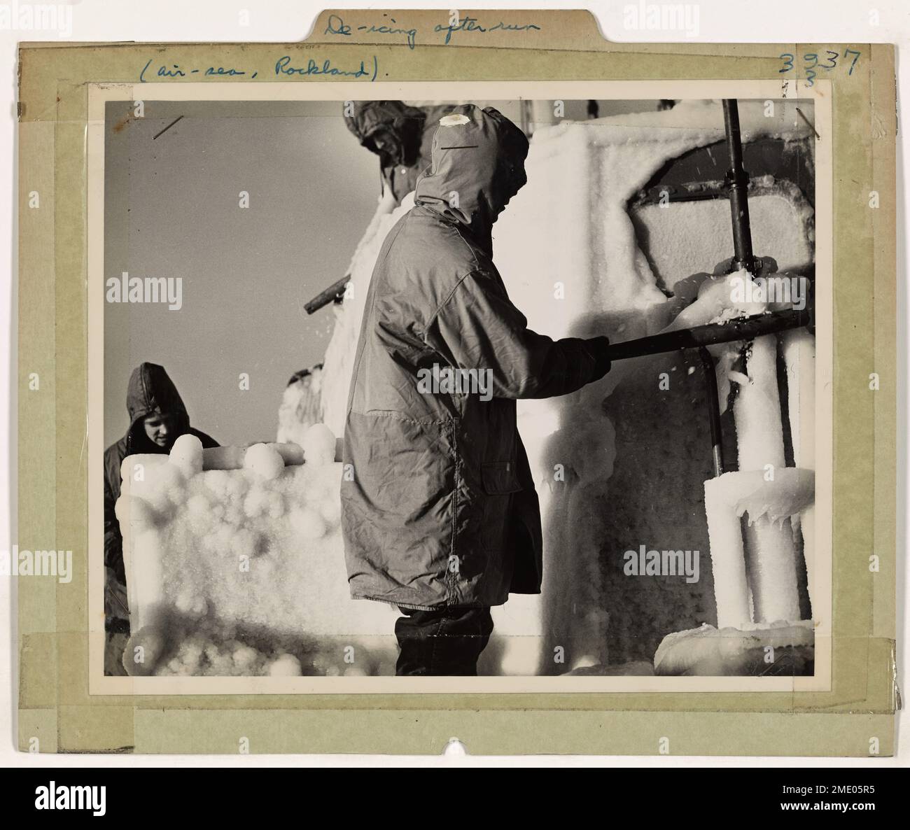 Coast Guardsmen are seen de-icing their vessel after a winter patrol in ...