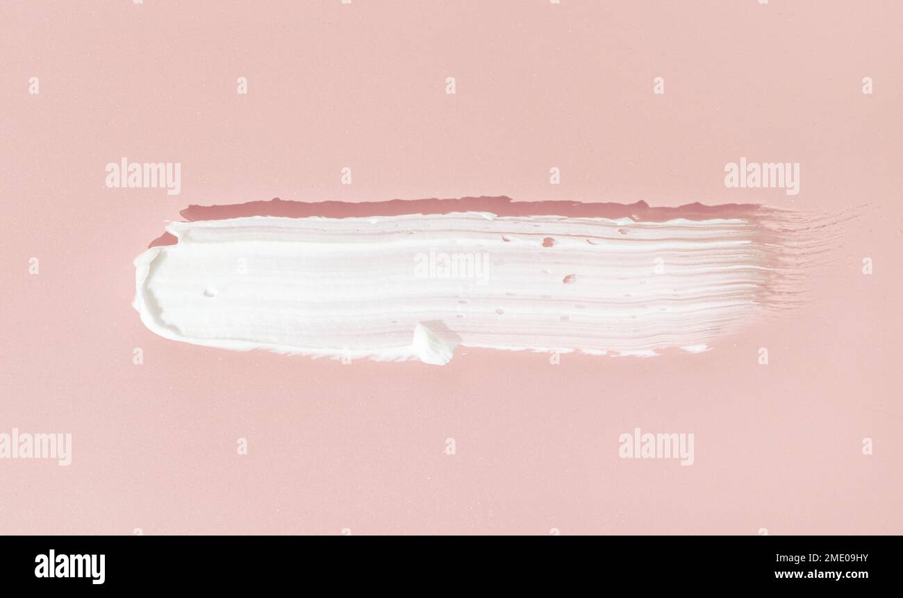 White Cosmetic cream smear isolated on pink background. Skin care ...