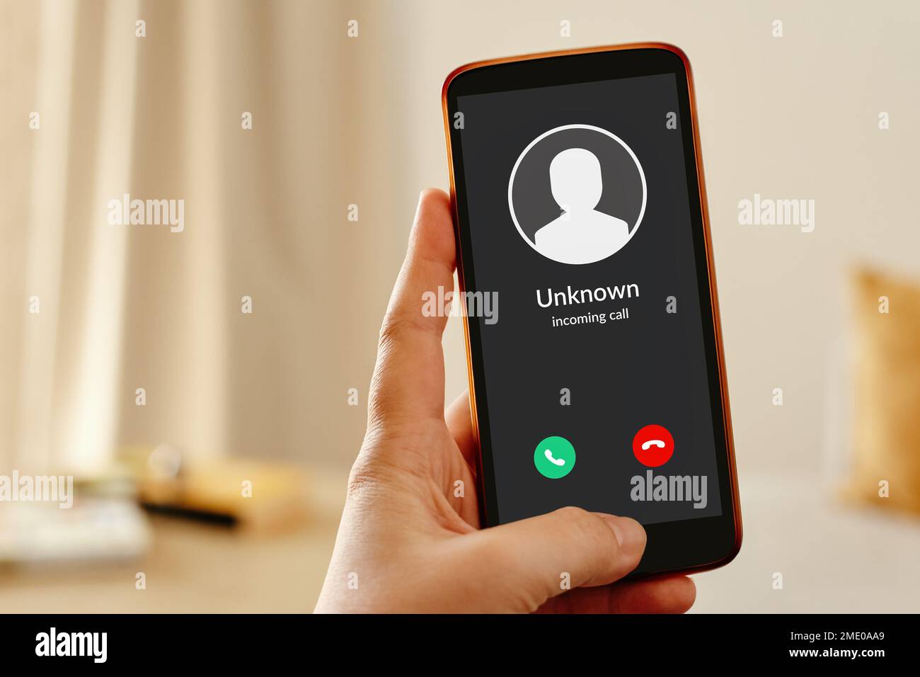 Female hand holding a mobile smartphone displaying an incoming call ...