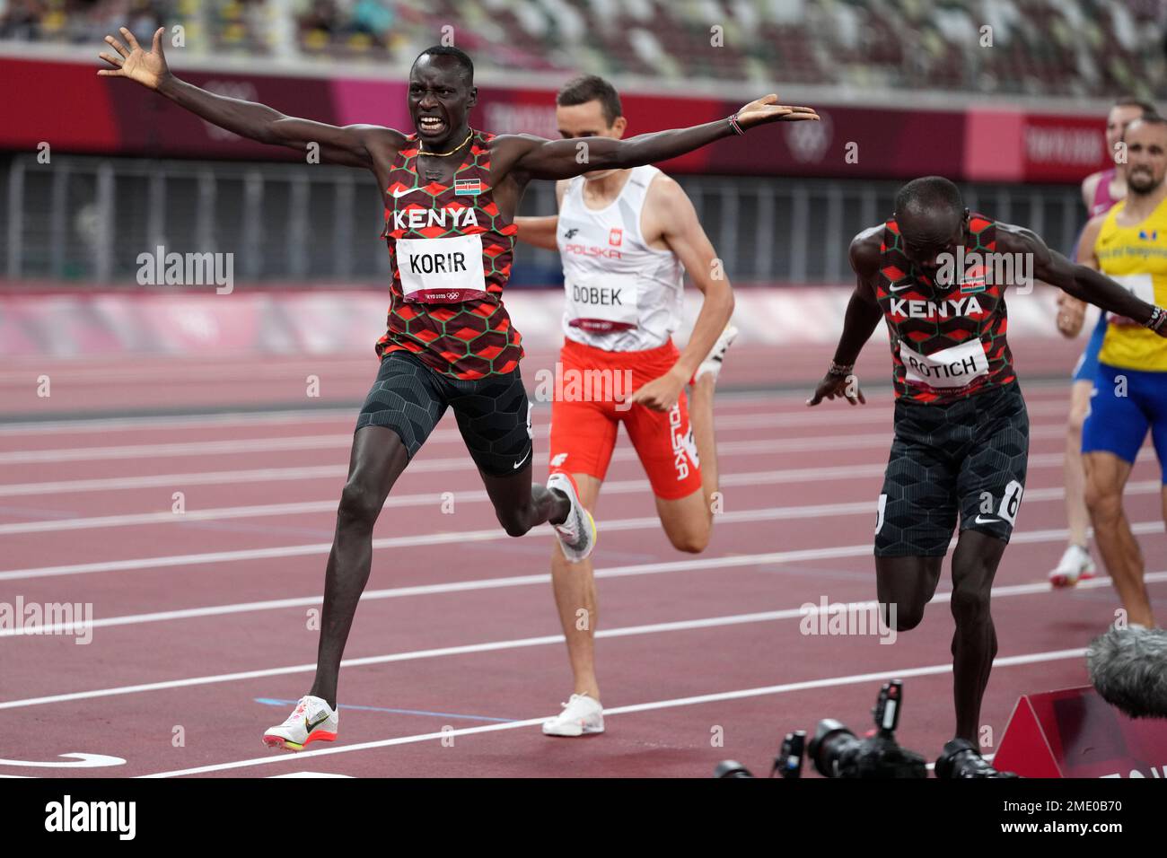 Emmanuel Korir, of Kenya, reacts as he crosses the finish line to win ...
