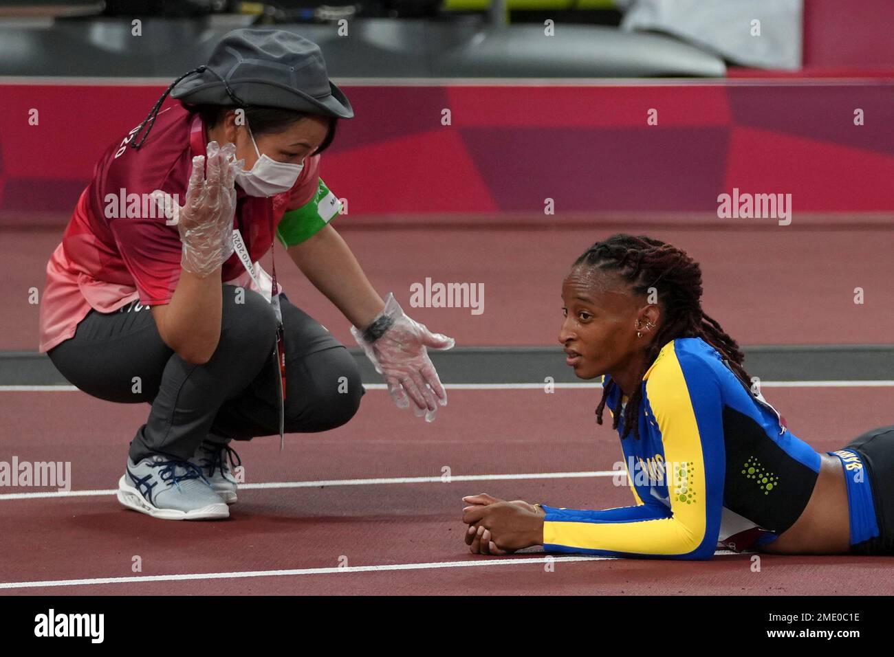 A track marshal gestures to Sada Williams, of Barbados, after a ...