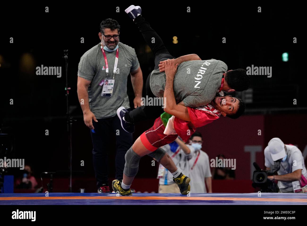 Iran's Mohammedreza Geraei celebrates with his coach defeating Ukraine ...