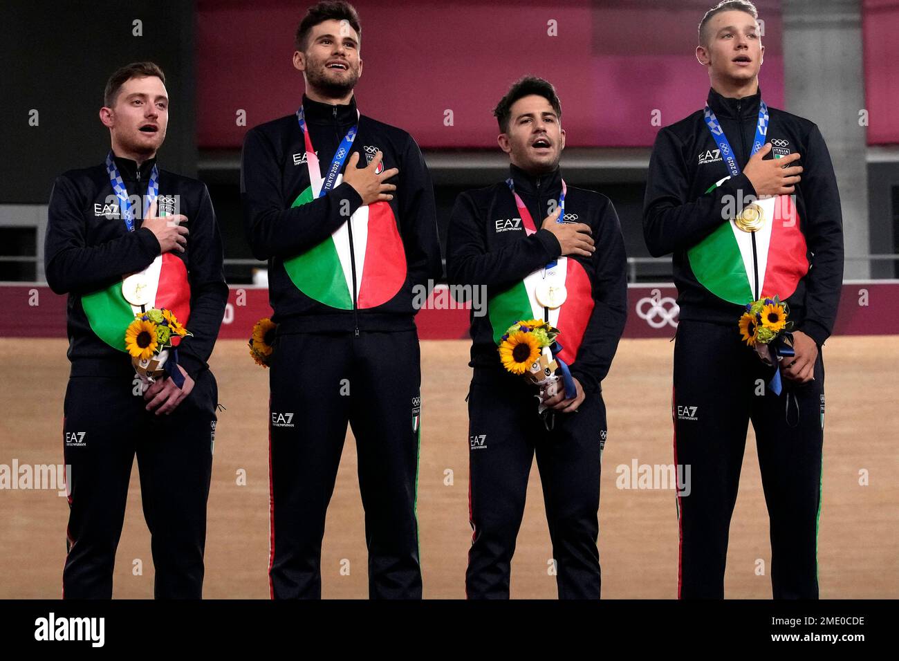 Team Italy sing their national anthem with their gold medals during a ...