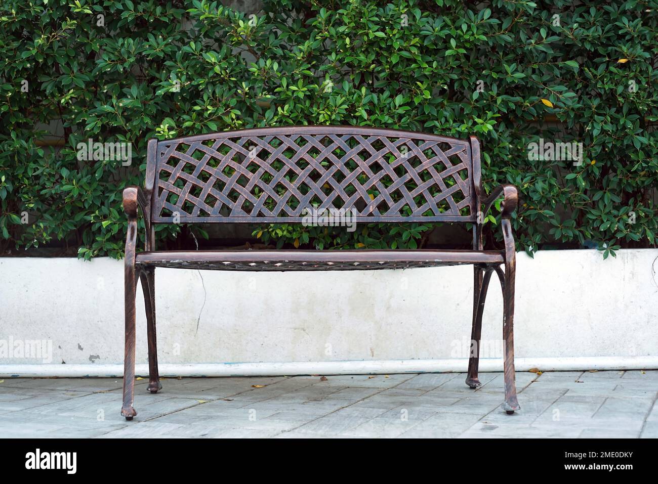 A steel chair on footpath in the parks Stock Photo - Alamy