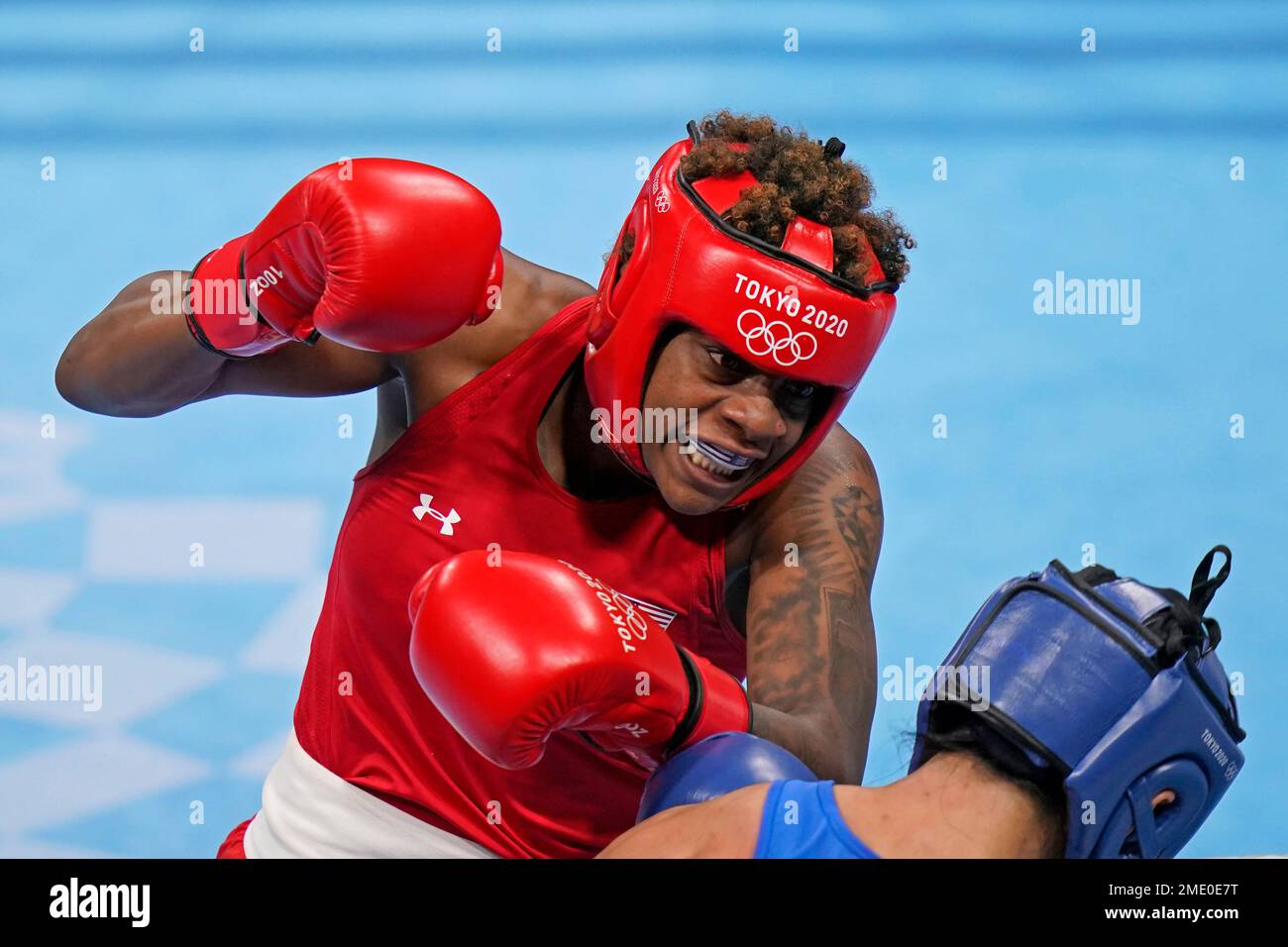Oshae Jones, of the United States, in red, delivers a punch to Hong Gu ...