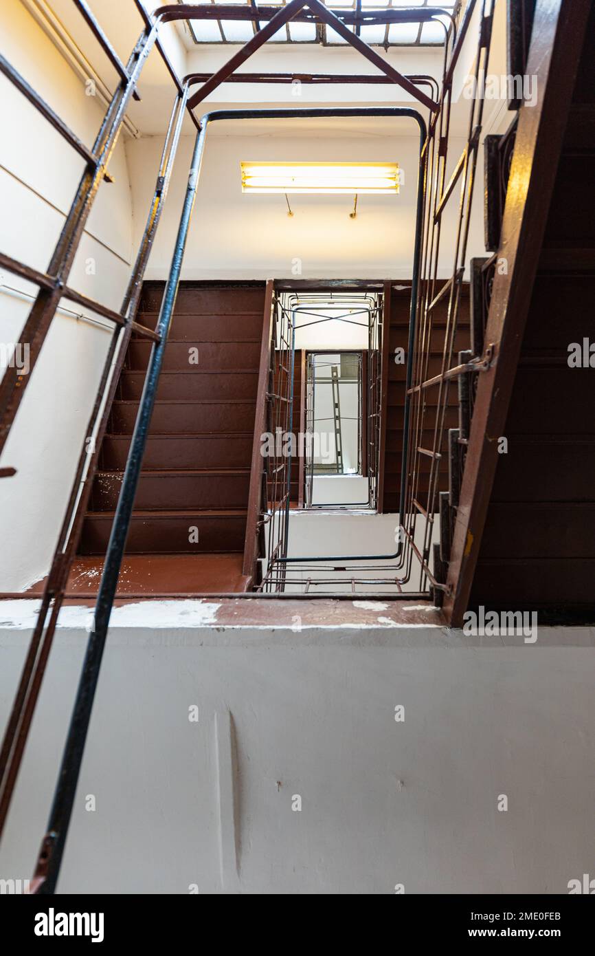 Look up to old high square spiral stairscase in old tenement building ...