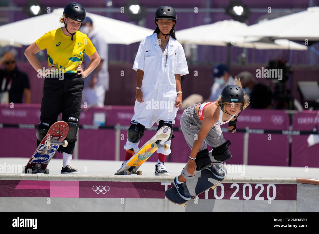 Sky Brown of Britain, right, warms up for the women's park ...