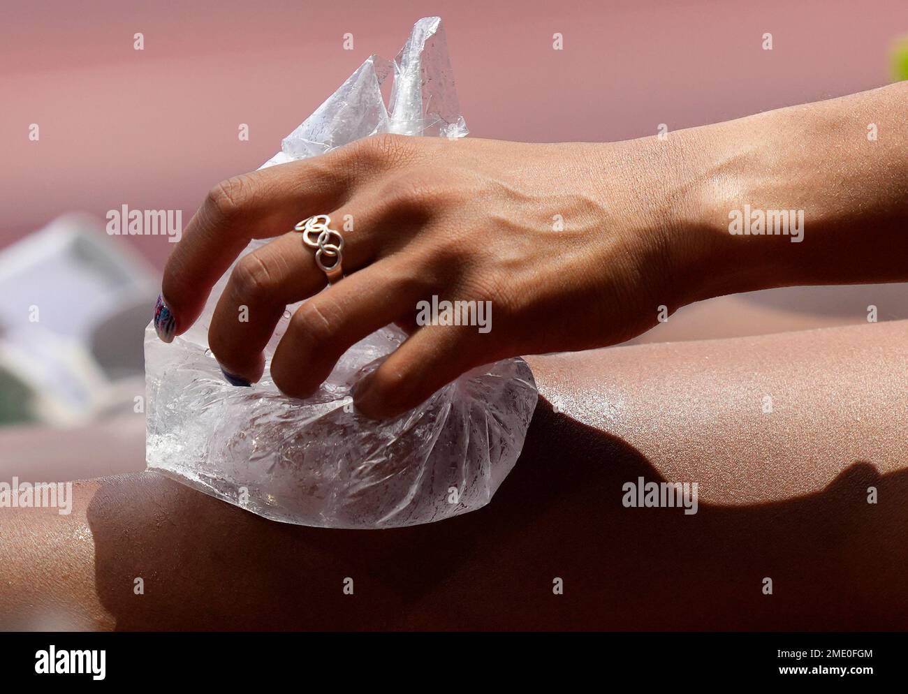 A competitor puts ice on their knee during the high jump of the ...