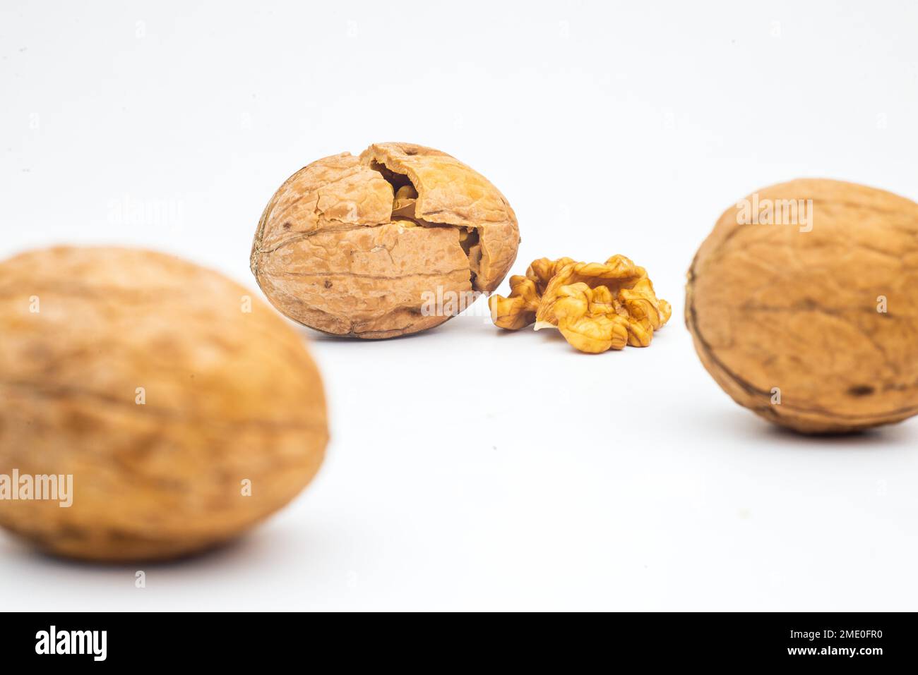 Walnut with leaf isolate. Walnuts peeled and unpeeled with leaves on ...
