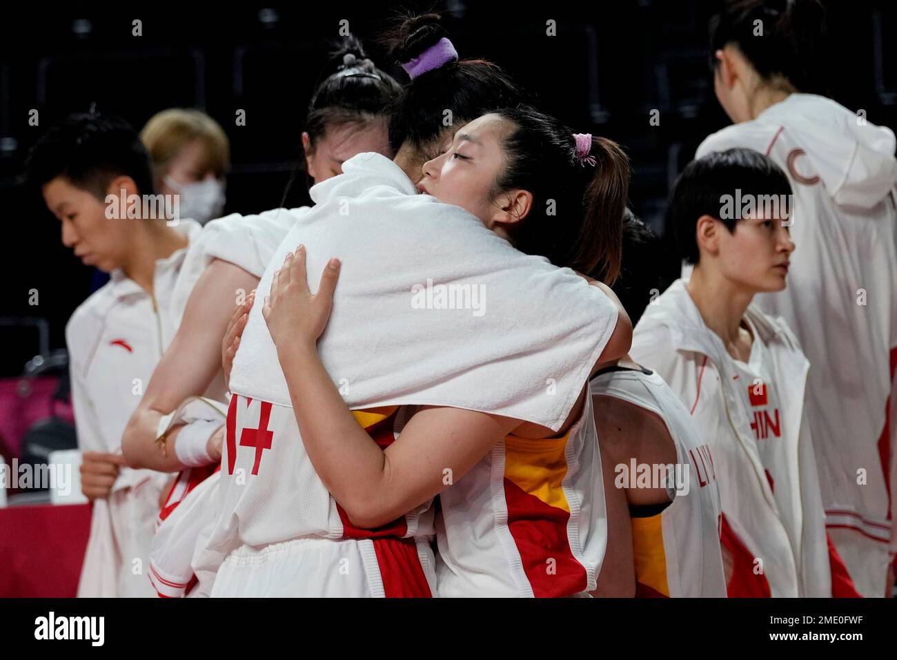 China's Yueru Li (14) and teammate Yuan Li embrace following their loss ...